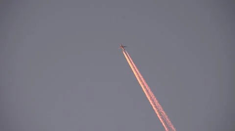 ULTRA HD 4K Fallow plane trail sunset bl... | Stock Video | Pond5