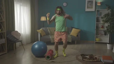 An unathletic man enters the room bounci... | Stock Video | Pond5
