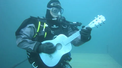 Underwater fun of playing a guitar solo ... | Stock Video | Pond5