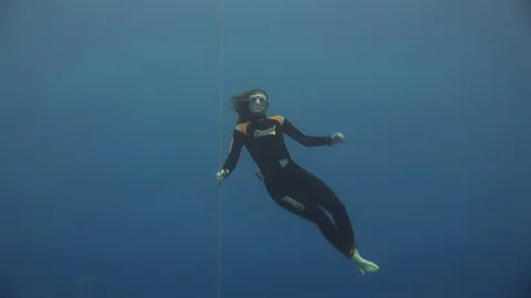 Underwater model free diver swims with r... | Stock Video | Pond5