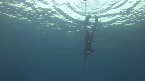 Underwater model free diver swims with r... | Stock Video | Pond5