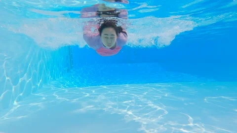 Underwater scene of Young woman swimming... | Stock Video | Pond5