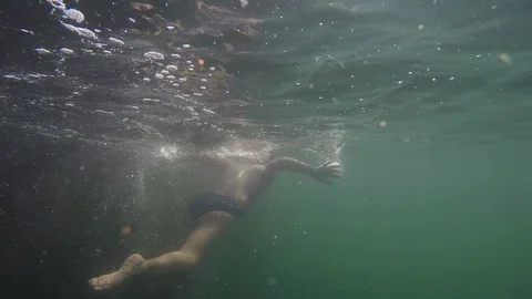 underwater view of a floating boy | Stock Video | Pond5