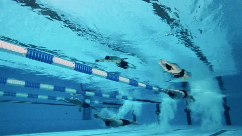 Underwater view of three swimmers jumpin... | Stock Video | Pond5