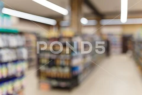 Unfocused shot of supermarket interior. Blurry hypermarket, mall ...