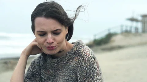 Unhappy, sad woman sitting on beach duri... | Stock Video | Pond5