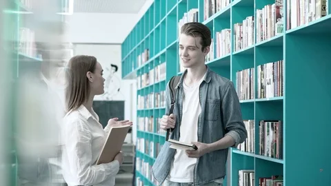 University friends talking in library | Stock Video | Pond5