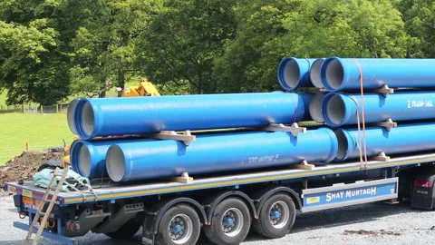 Unloading hydro pipes for the New Rydal ... | Stock Video | Pond5