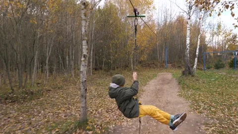 unsafe fast descent on a zip line. a boy... | Stock Video | Pond5