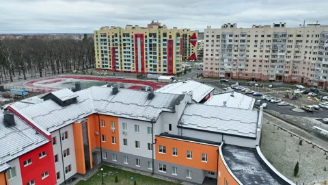 Unusual design of school building among ... | Stock Video | Pond5