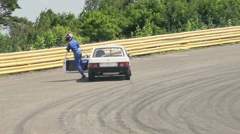 Upset driver leaving broken race car on ... | Stock Video | Pond5