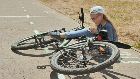Upset girl crying after falling from a b... | Stock Video | Pond5