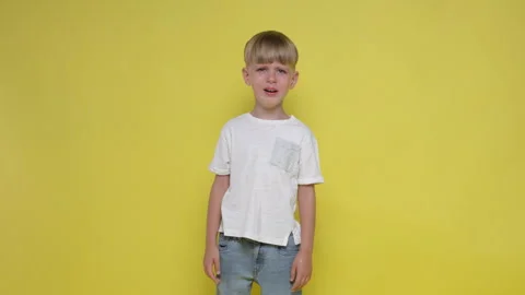 Upset little boy is crying on a yellow b... | Stock Video | Pond5
