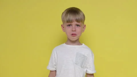Upset little boy is crying on a yellow b... | Stock Video | Pond5