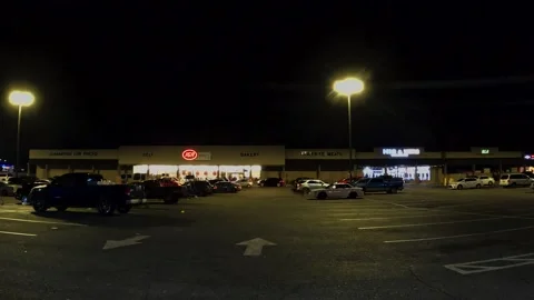 Urban retail strip mall at night IGA gro... | Stock Video | Pond5