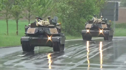 us army tanks rolling down a wet road | Stock Video | Pond5