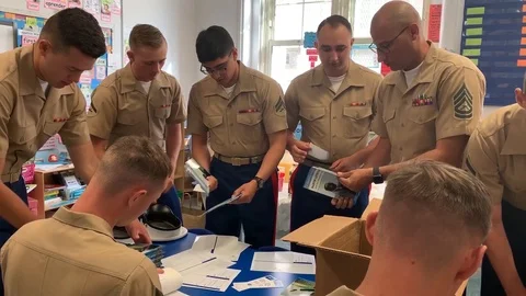 U.S. Marines sorting books read to schoo... | Stock Video | Pond5