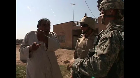 US soldiers interrogate a man in a town ... | Stock Video | Pond5