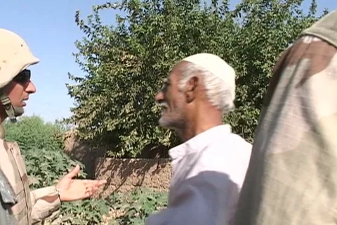 US Soldiers interrogate an old man on th... | Stock Video | Pond5
