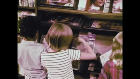 USA - 1975 - Kids enjoy magazines and ot... | Stock Video | Pond5