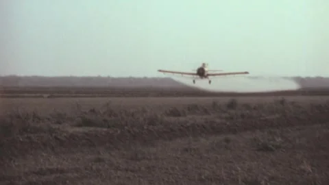 USA - 1982: A crop duster plane spraying... | Stock Video | Pond5