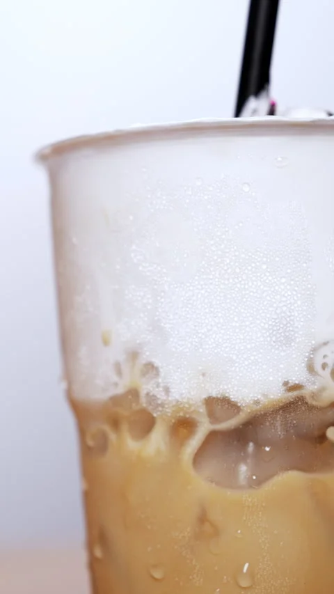 Use a straw to drink cold espresso in a ... | Stock Video | Pond5