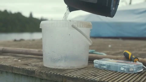 Using boiling water to heat rubber pipe ... | Stock Video | Pond5