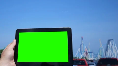 Using a green screen tablet by an amusem... | Stock Video | Pond5