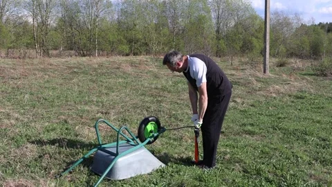Using hand operated pneumatic pump, farm... | Stock Video | Pond5