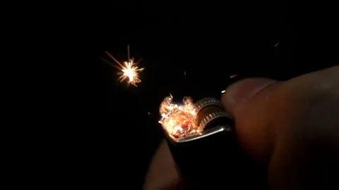Using a lighters hand on a black backgro... | Stock Video | Pond5