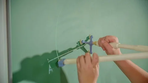 Using a pair of compasses to draw someth... | Stock Video | Pond5