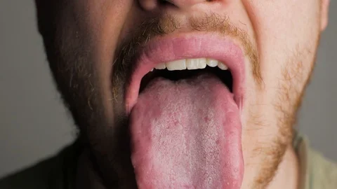 using a tongue cleaner | Stock Video | Pond5