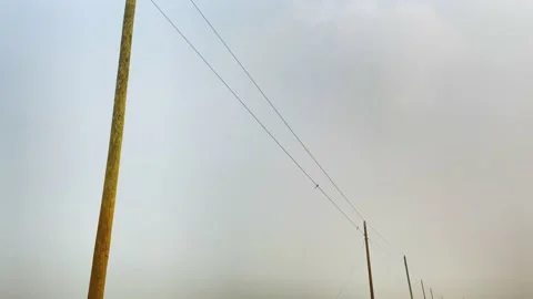 Utility pole and lines reveals row of po... | Stock Video | Pond5