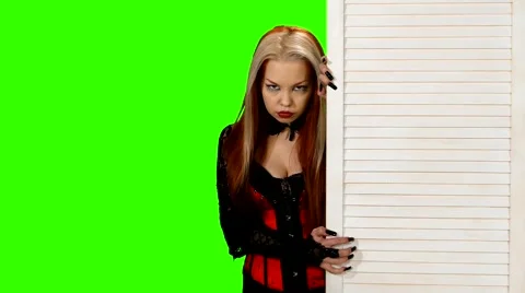 Vampire woman peeking out from behind th... | Stock Video | Pond5