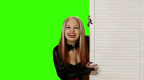 Vampire woman peeking out from behind th... | Stock Video | Pond5