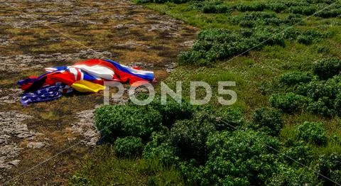 Various national flags in a heap on the ground as a sign of cooperation ...