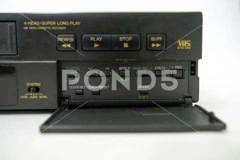 VCR with old VHS tapes and remote control - Stock Image #279398201