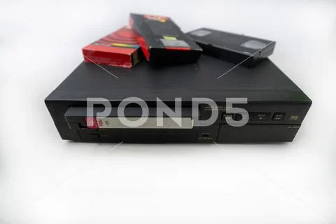 VCR with old VHS tapes and remote control - ~ Premium Photo #279398229