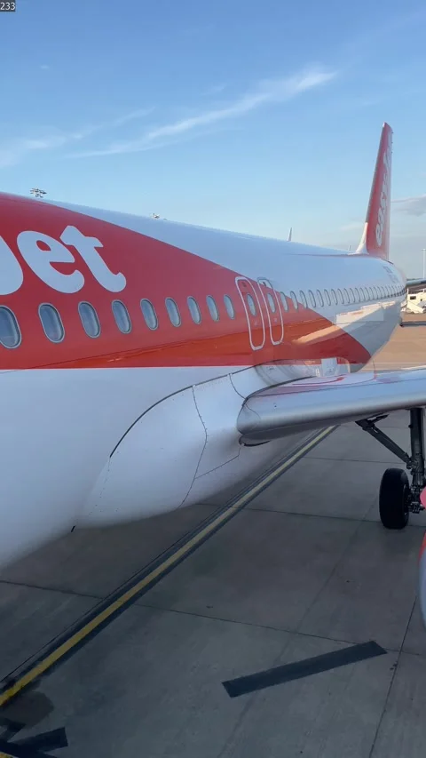 vertical 4K panning easyjet orange and w... | Stock Video | Pond5