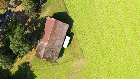 Vertical aerial view of a barn on the ed... | Stock Video | Pond5