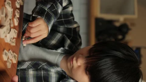 Vertical : Asian boy playing Shogi game,... | Stock Video | Pond5