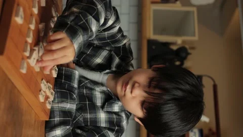 Vertical : Asian boy playing Shogi game,... | Stock Video | Pond5