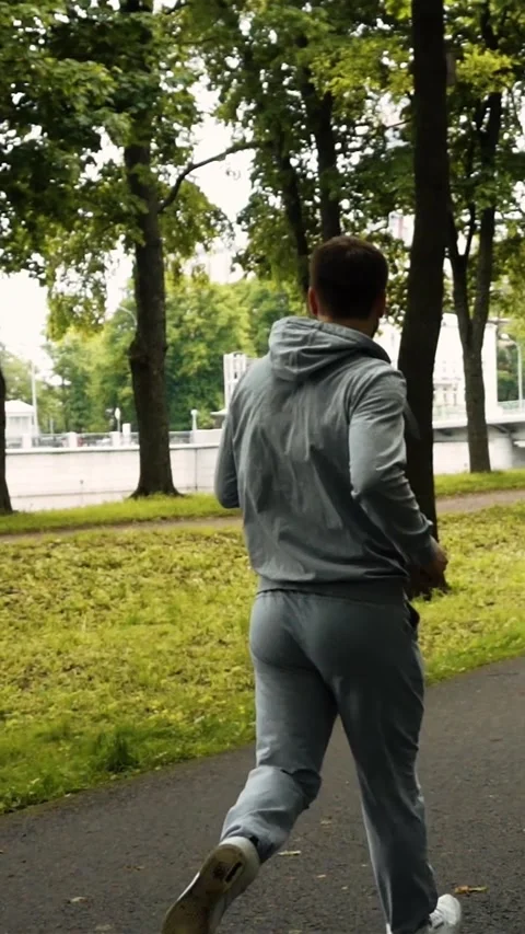 Vertical of Back view of man running in ... | Stock Video | Pond5