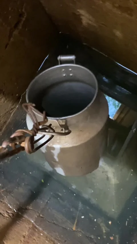 vertical bucket on a chain is lowered in... | Stock Video | Pond5