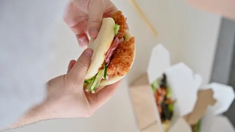 Vertical footage of man eating bao bun.A... | Stock Video | Pond5