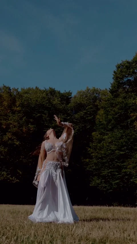 Vertical. Girl belly dancing in the fore... | Stock Video | Pond5