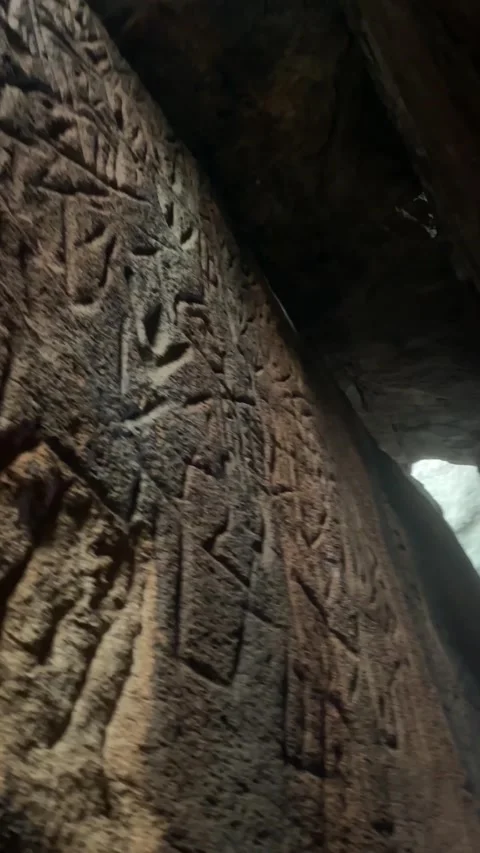 Vertical of letter carvings in a cave in... | Stock Video | Pond5