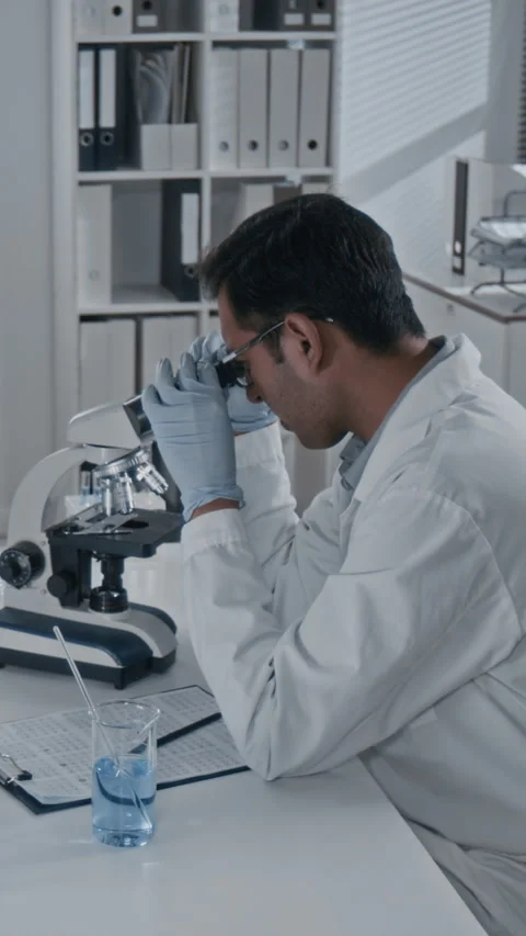 Vertical of Male Lab Worker Analysing Sa... | Stock Video | Pond5