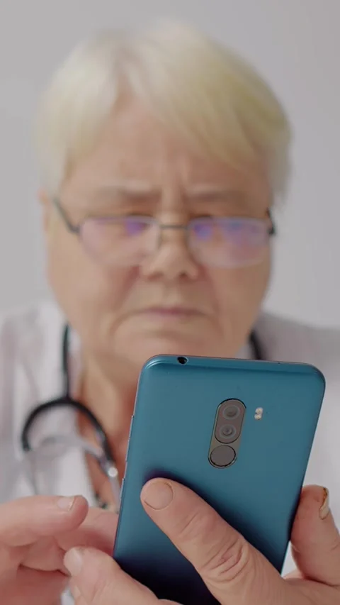 Vertical Screen Nurse scrolling on smart... | Stock Video | Pond5