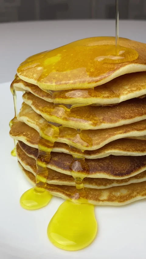 Vertical screen: Pouring syrup over stac... | Stock Video | Pond5